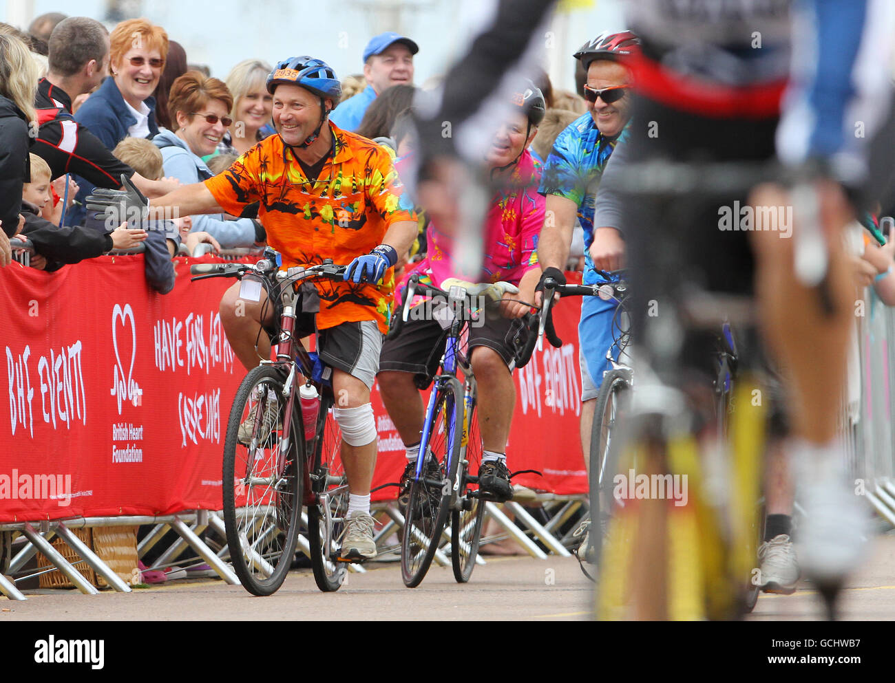 Riders greet the crowd as they cross the finishing line in Brighton ...