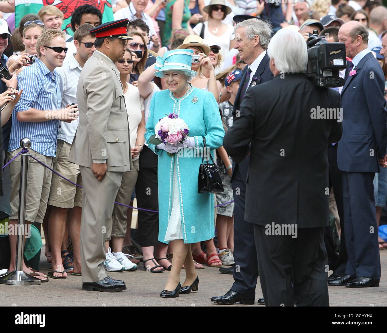 Britain's Queen Elizabeth II (centre) meets tennis fans on Murray Mount ...