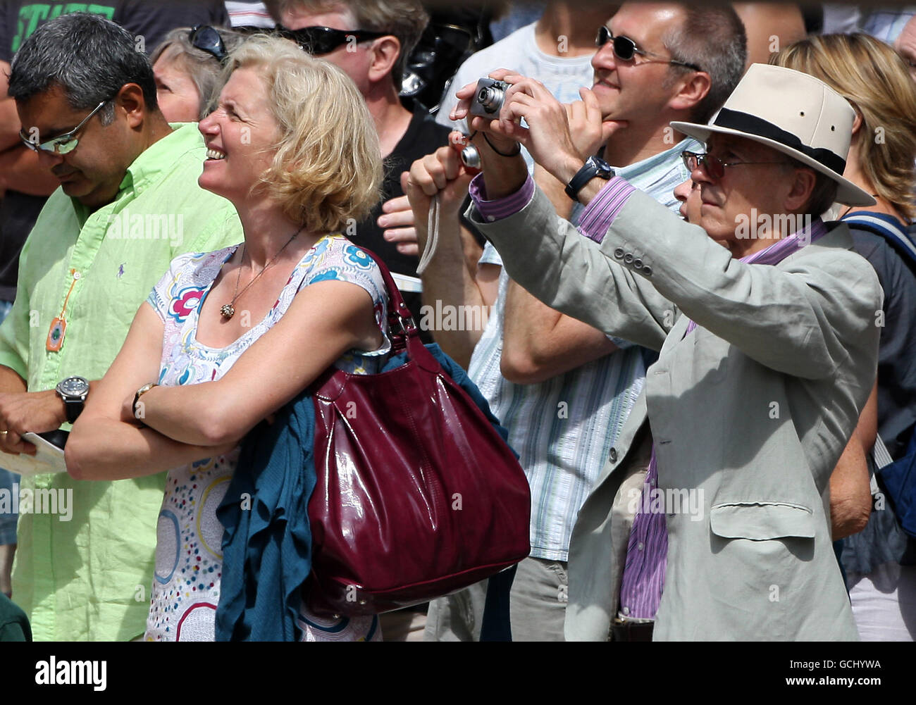 Fans take photographs of Queen Elizabeth II as she arrives at Wimbledon ...