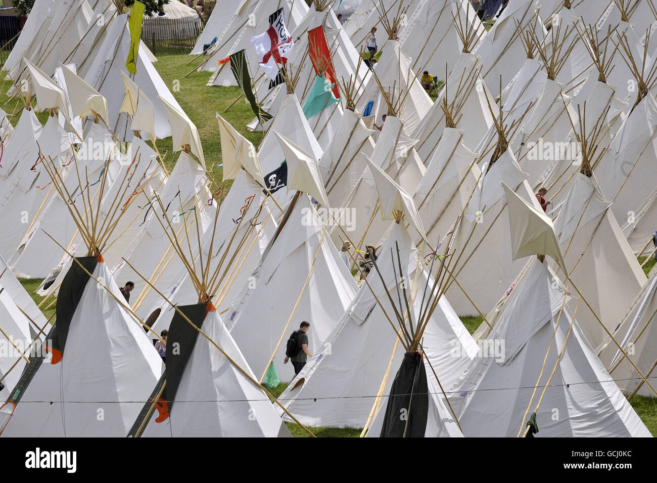 A man walks through the teepee field on the day the music begins at ...