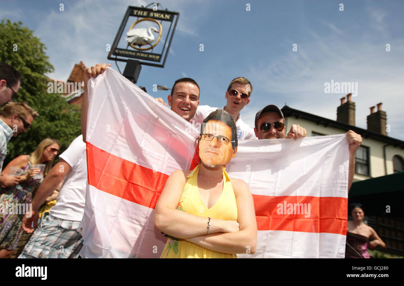 An England fan wearing a Fabio Capello mask prepares to watch the match ...