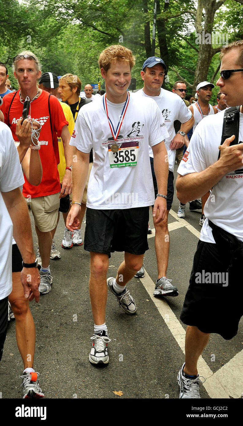 Prince Harry with a medal round his neck after completing a charity run ...