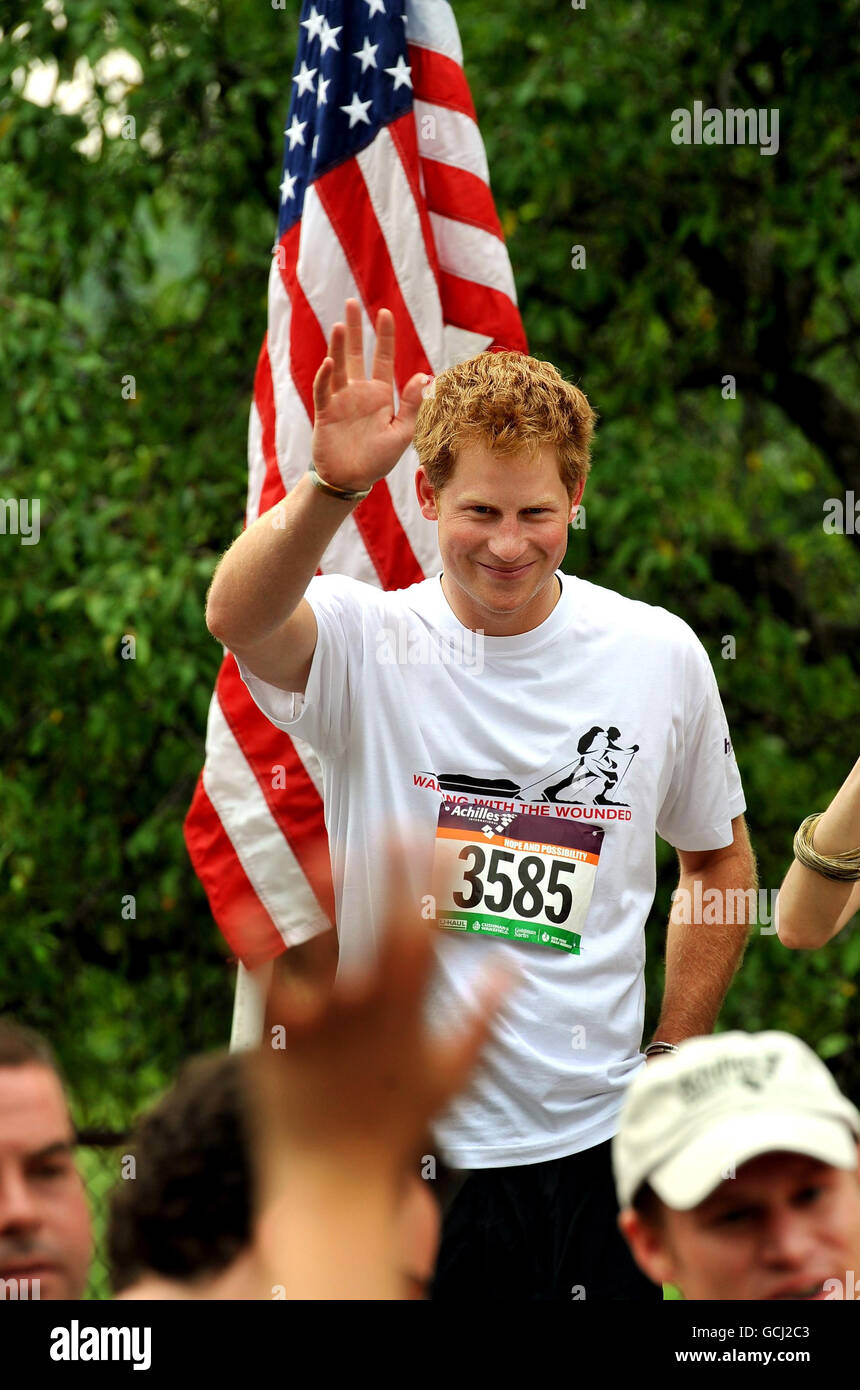 Prince Harry waves to runners after starting a charity run through ...