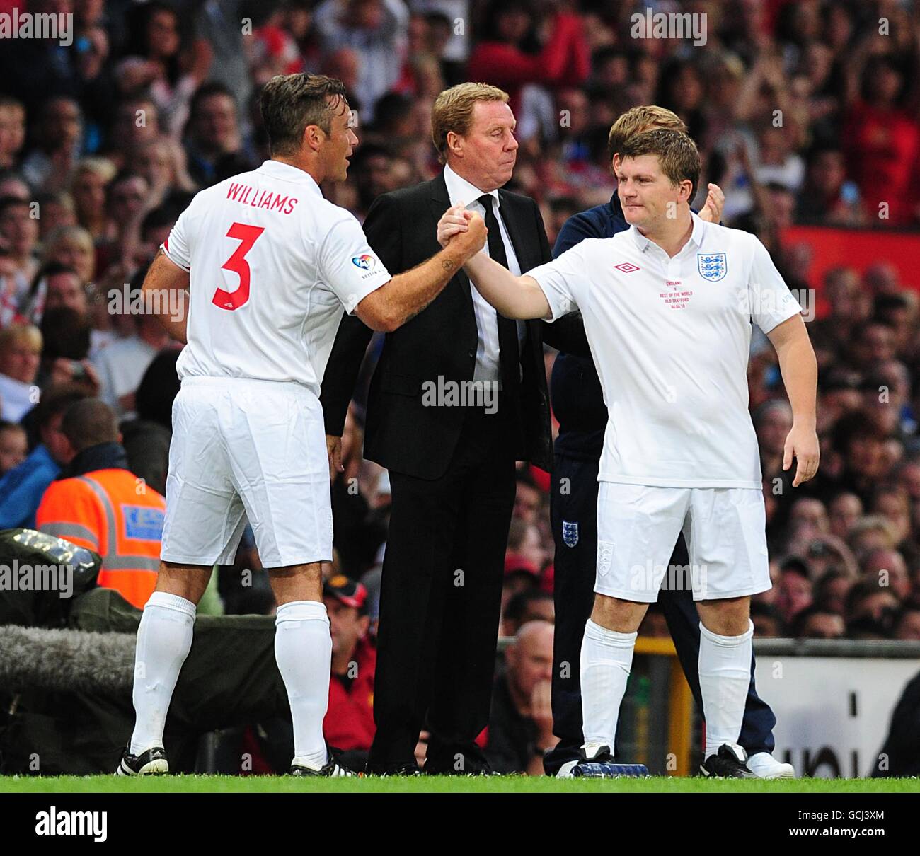Robbie Williams (left) shakes hands with Ricky Hatton (right) during ...