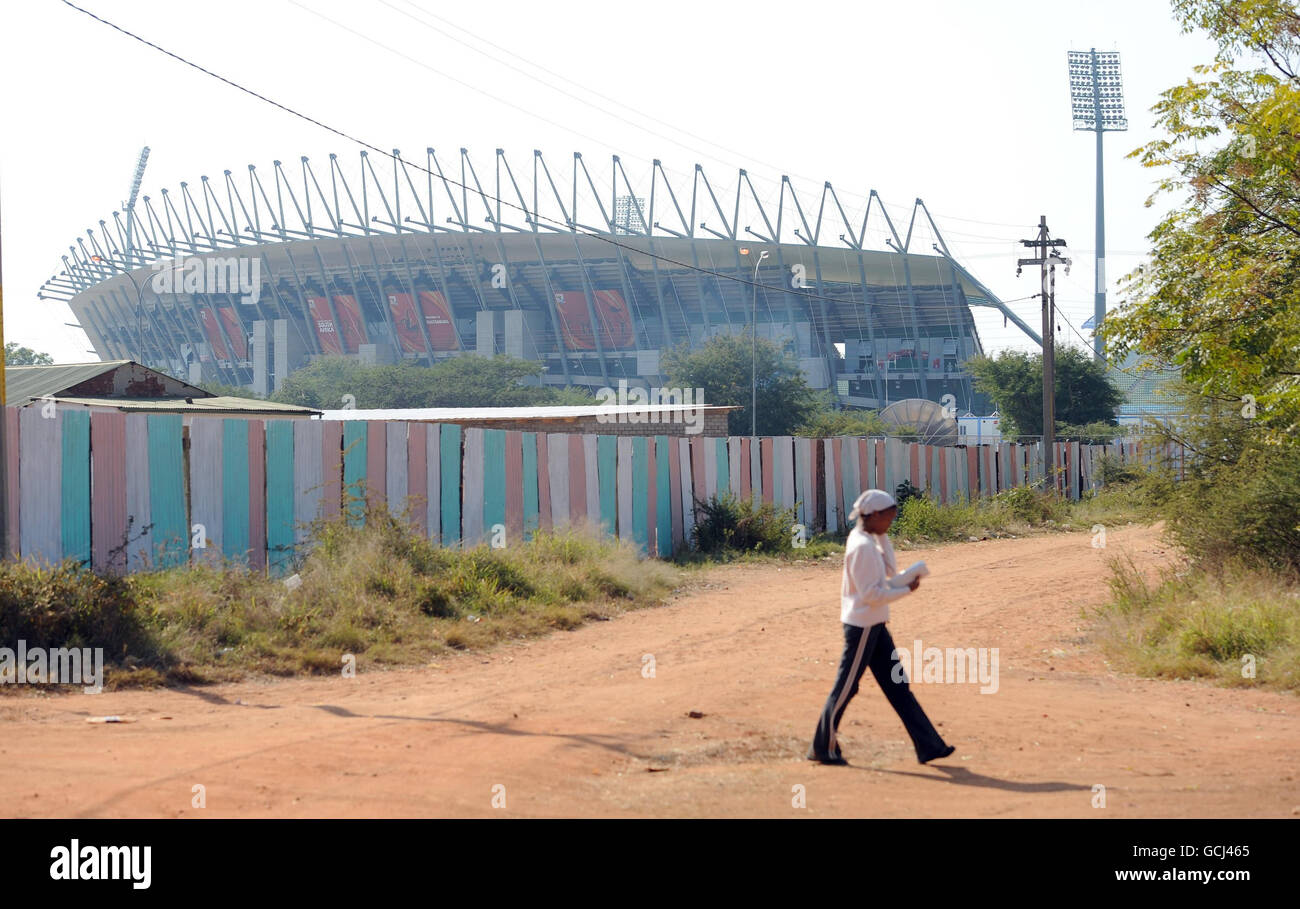 A girl from the Bafokeng tribe walks opposite the Royal Bafokeng ...
