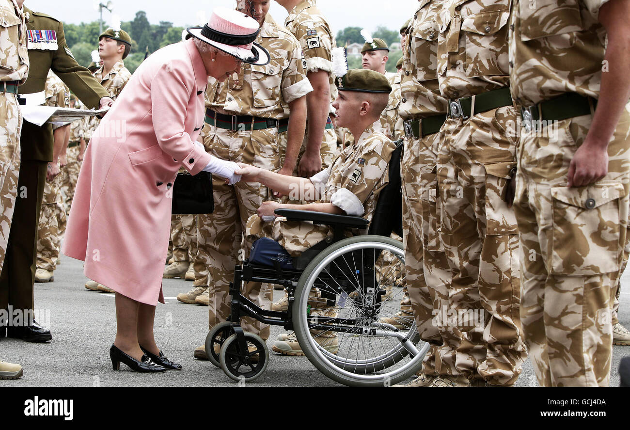 Britain's Queen Elizabeth II presents a Campaign Medal to Shaun Stocker ...