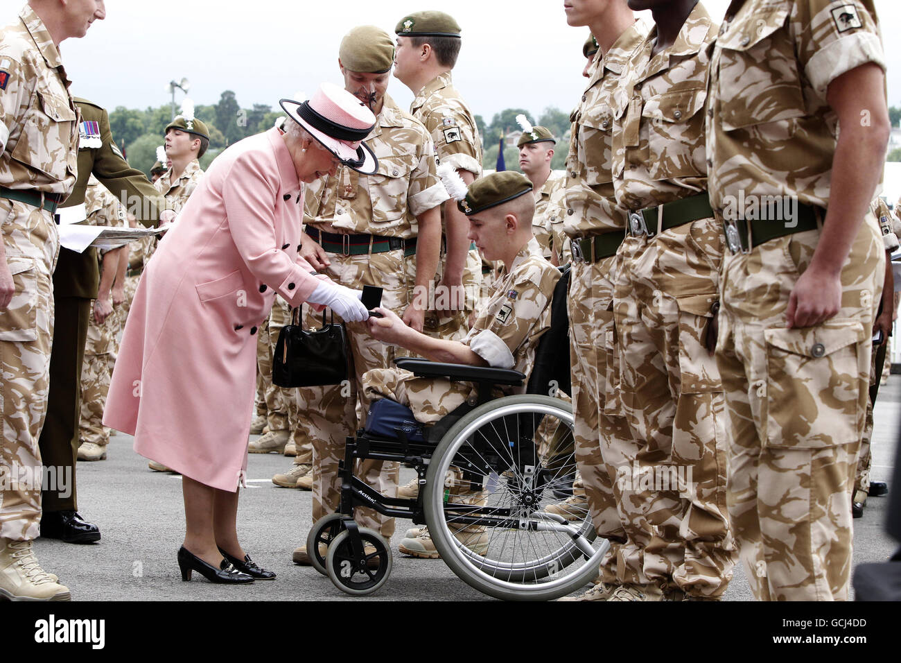 Britain's Queen Elizabeth II presents a Campaign Medal to Shaun Stocker ...