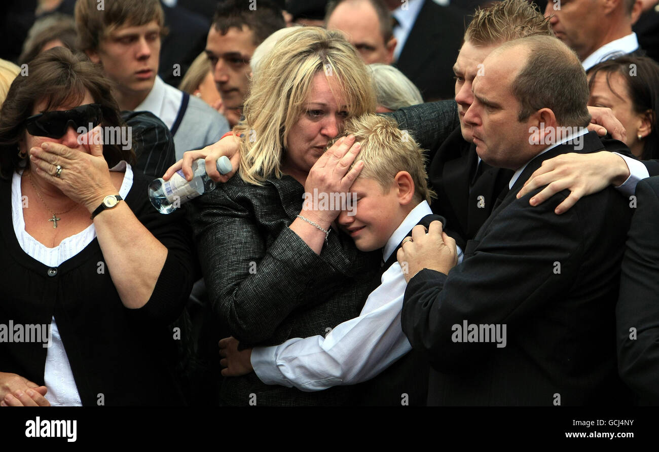 Nicola Hotine (centre), mother of Marine Anthony Hotine, 21, hugs her ...