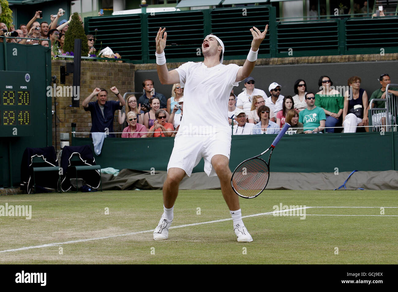 USA's John Isner celebrates victory over France's Nicolas Mahut in ...