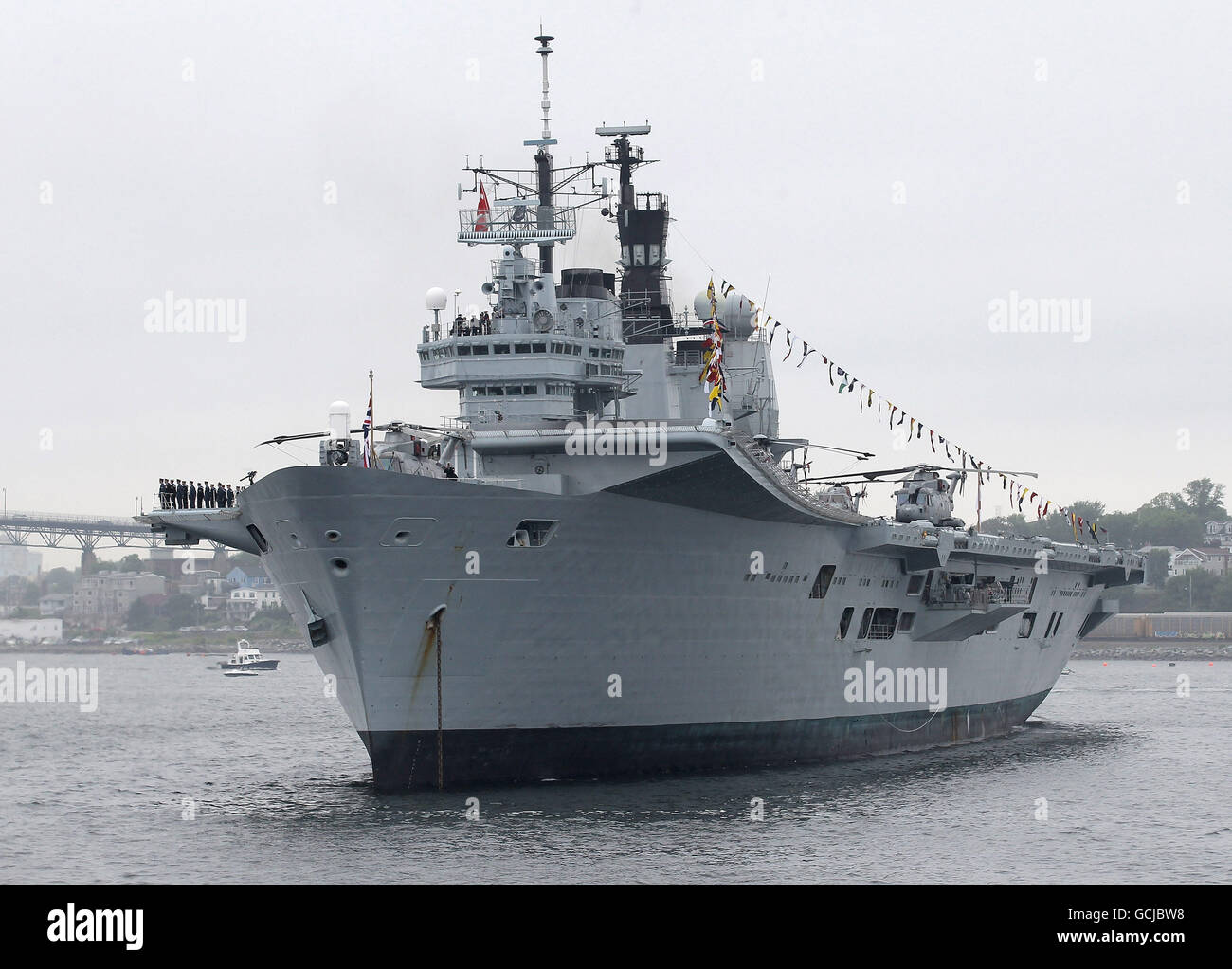 The crew of HMS Ark Royal salute as Britain's Queen Elizabeth II ...