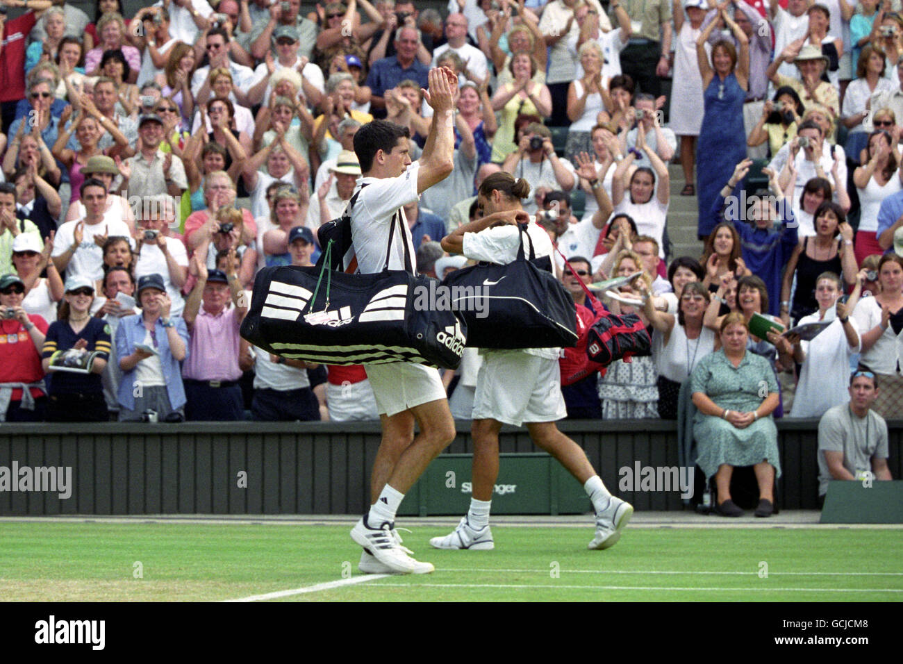 A partisan British crowd celebrate Tim Henman's victory as a dejected ...