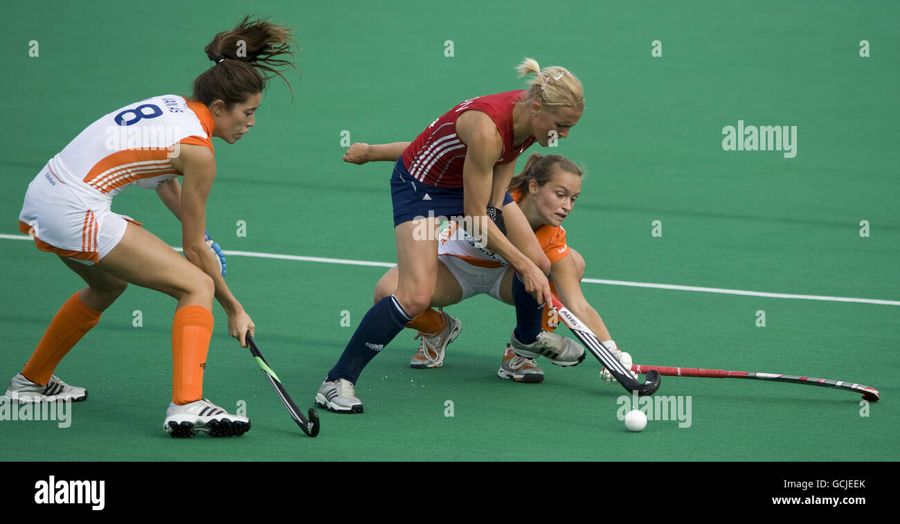 England's Alex Danson (centre) challenges with Netherlands' Kelly ...