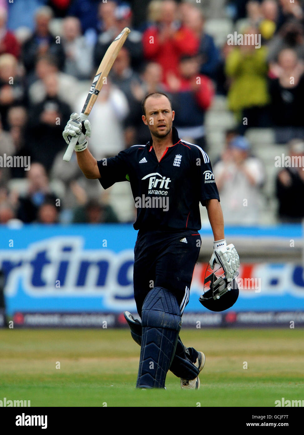 England's Jonathan Trott raises his bat in celebration after reaching a ...