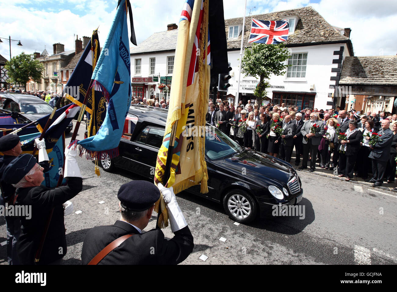 Flags are lowered as the bodies of Marine David Hart and Bombardier ...