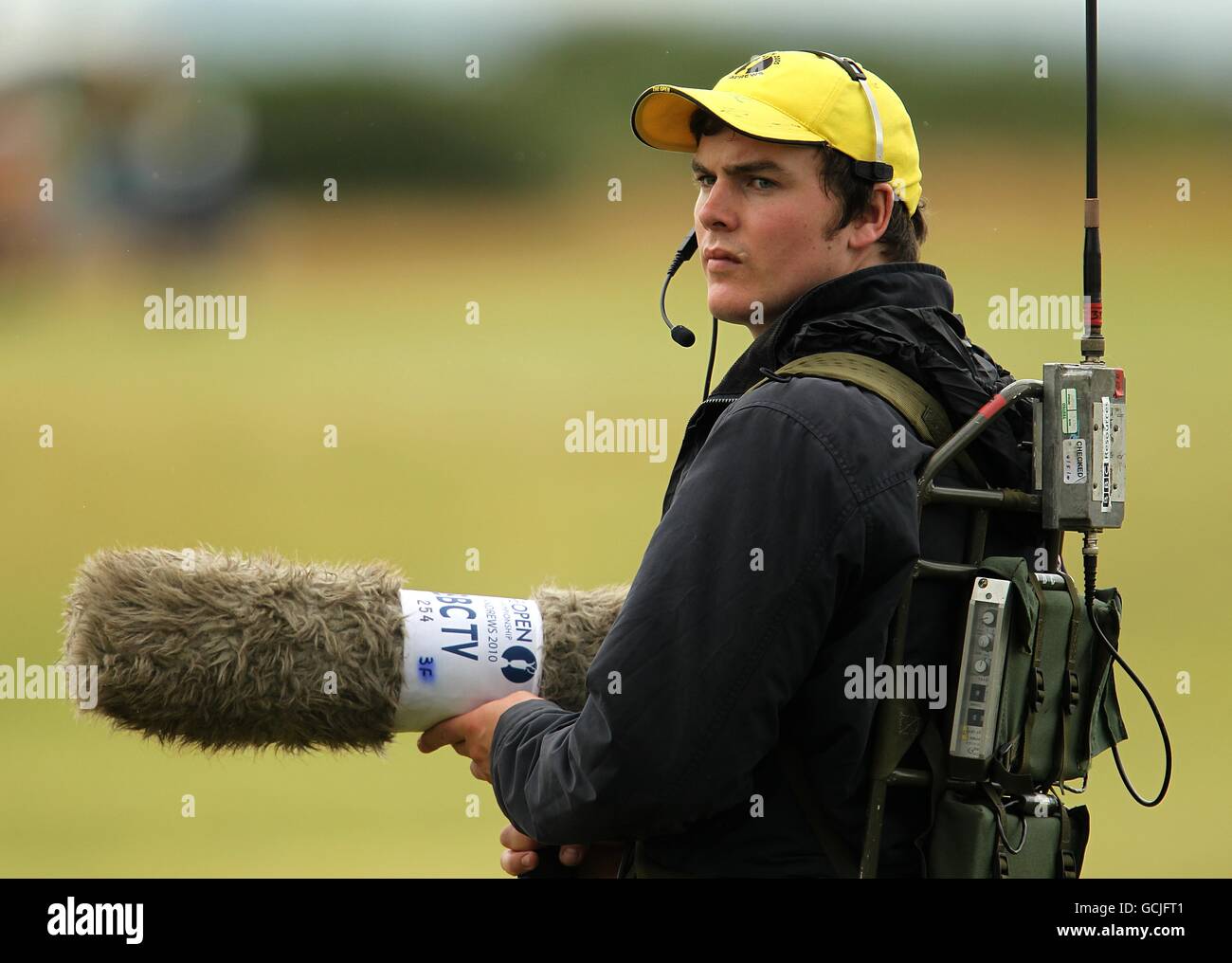 A BBC worker with a sound mic stands on the fairway during round one of ...