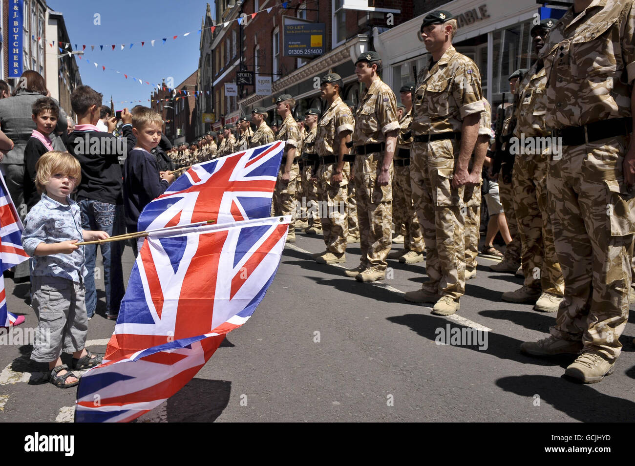 Gene Charlton (left), aged three, with other children wave Union flags ...