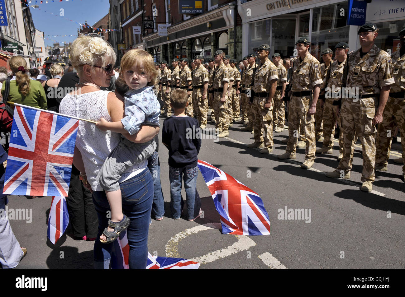 Gene Charlton, aged three, waves a Union flag as soldiers from A ...