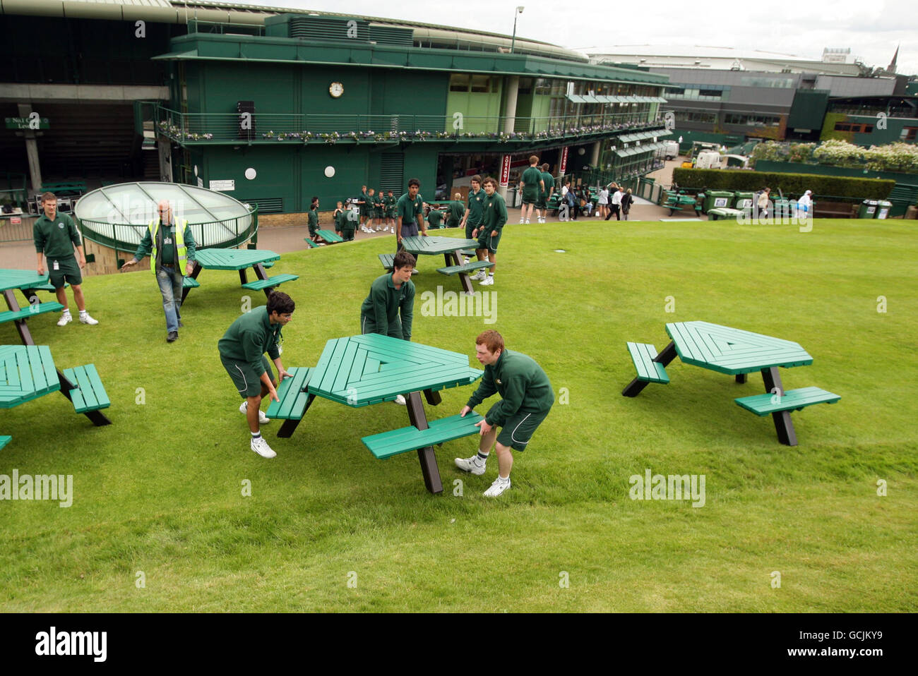 Ground staff prepare the benches on Murray Mount for the 2010 Wimbledon ...