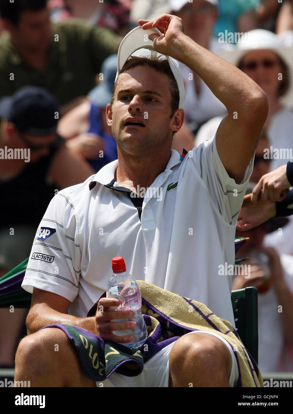 USA's Andy Roddick shades from the sun in his match against France's ...