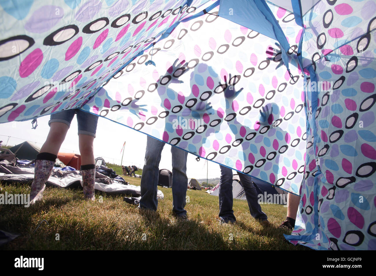 Festival Goers Setting Up Their Tents At Worthy Farm For The