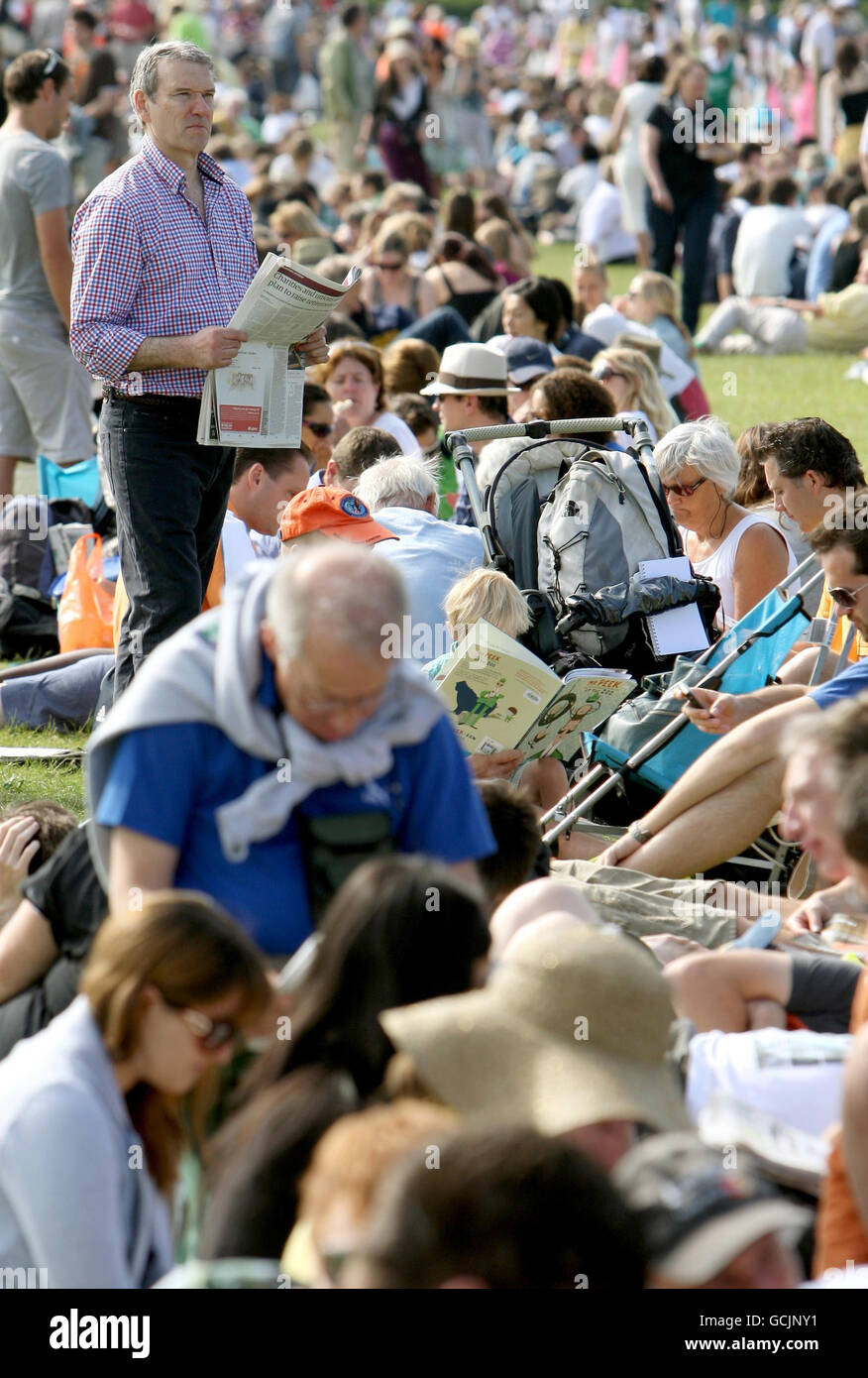 People queue in Wimbledon Park, in south west London, as they wait for ...