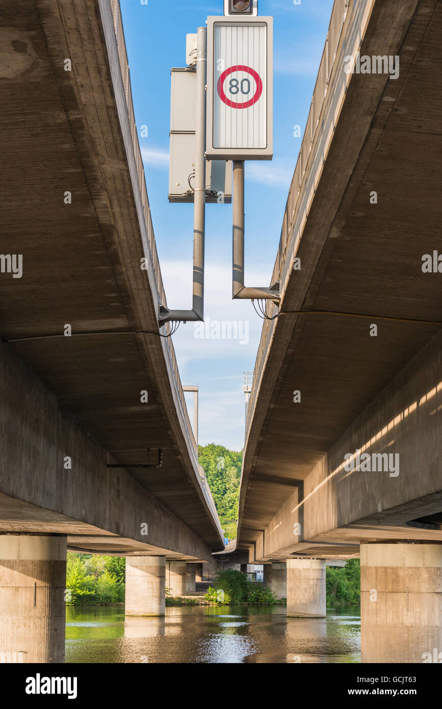 Motorway bridge with a speed limit road sign above the river danube ...