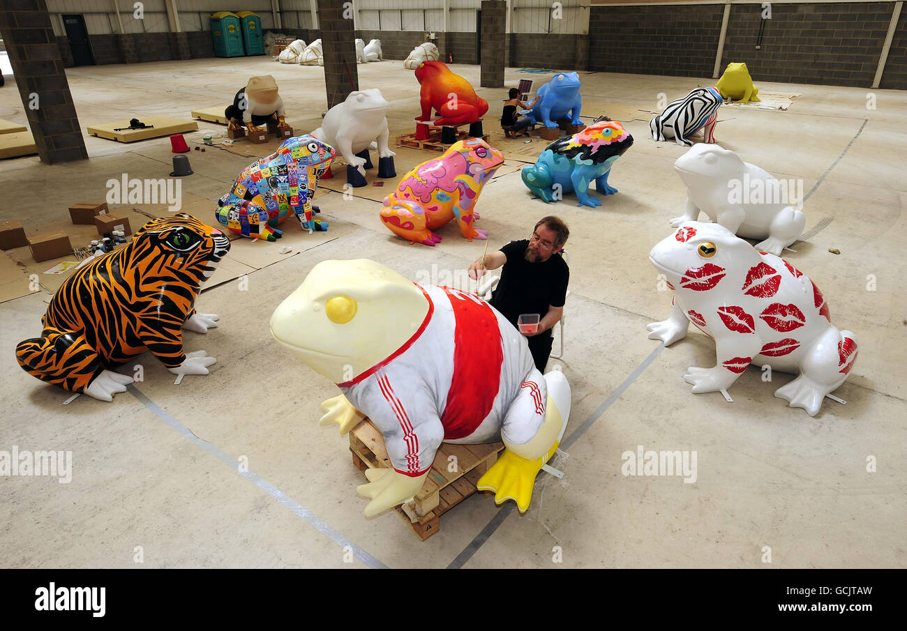 Artists at work painting some of the forty giant toads that will be ...