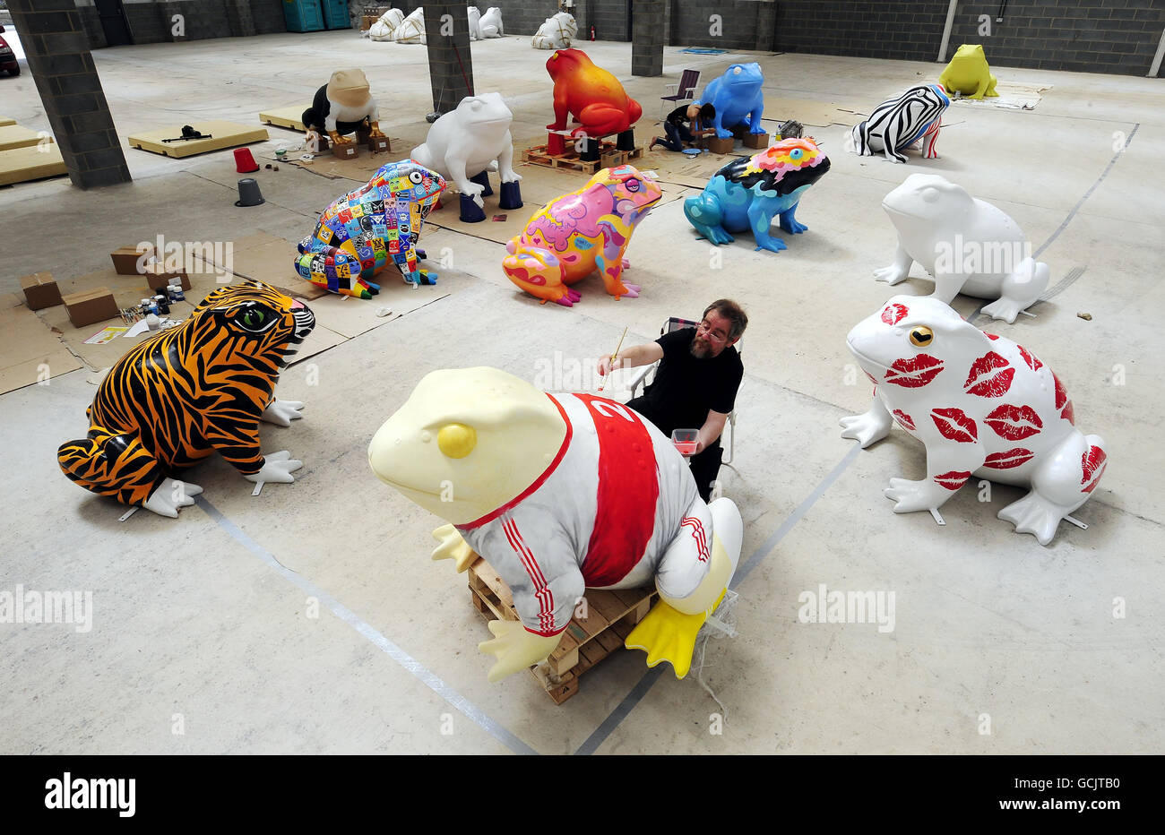 Artists at work painting some of the forty giant toads that will be ...