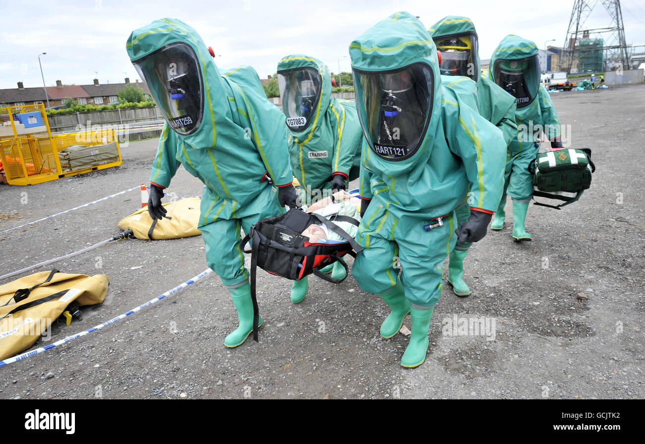Firefighters and NHS staff wearing gas tight suits carry a 'casualty ...