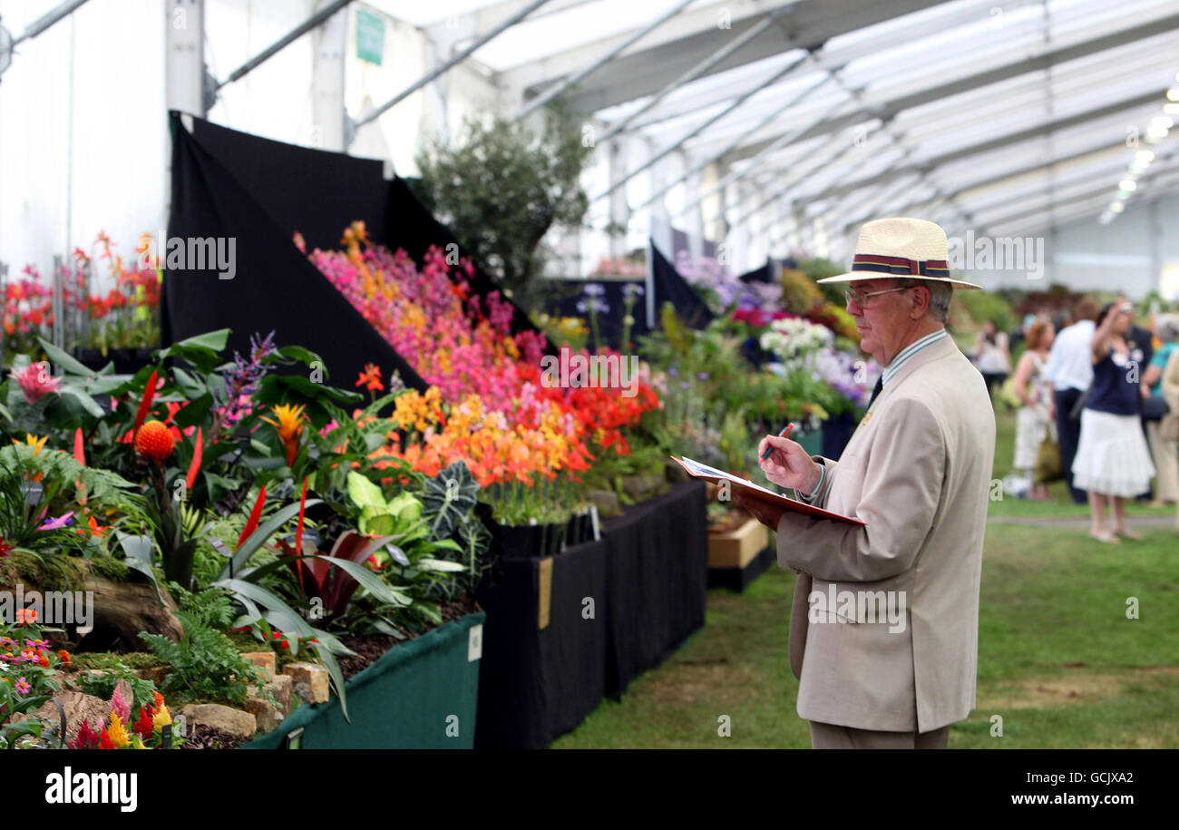 A judge inspects flowers at the Hampton Court Palace flower show ...