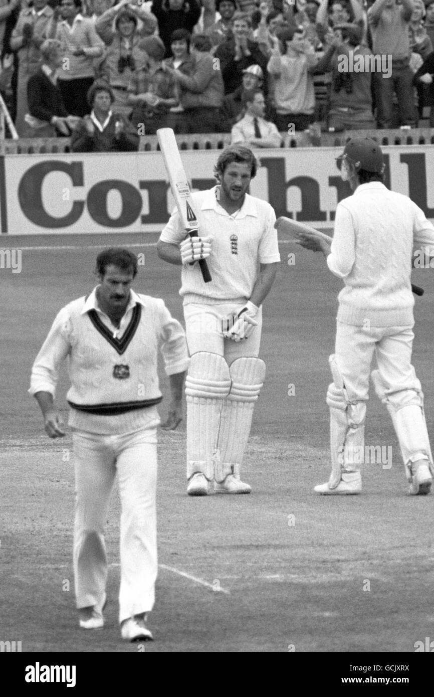 England's Ian Botham holds his bat aloft after reaching 50. He went on ...