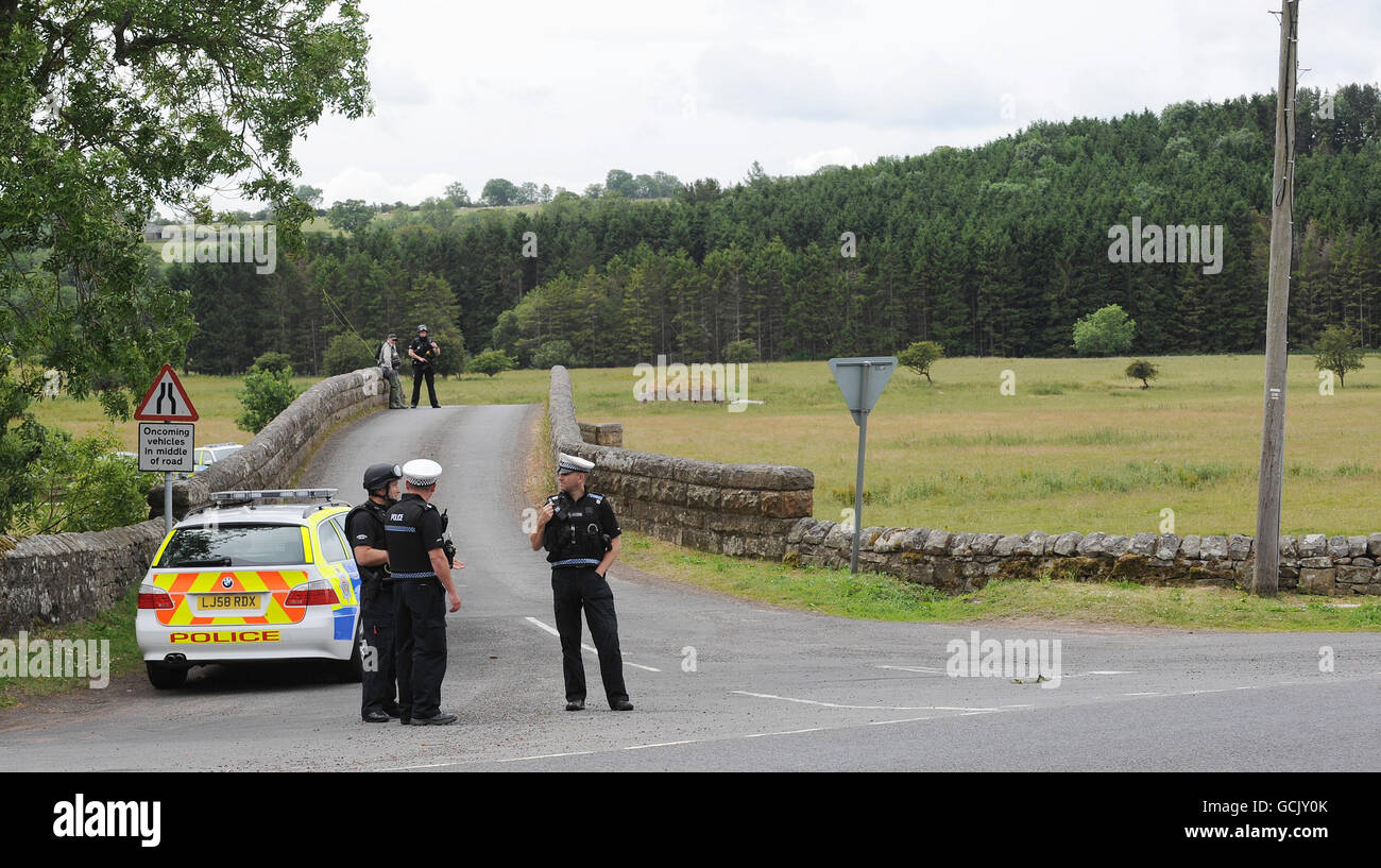 Arrmed police officers guard bridge in countryside outside rothbury hi ...