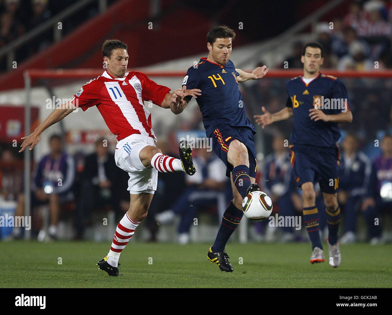 Spain's Xabi Alonso (right) and Paraguay's Jonathan Santana (left ...