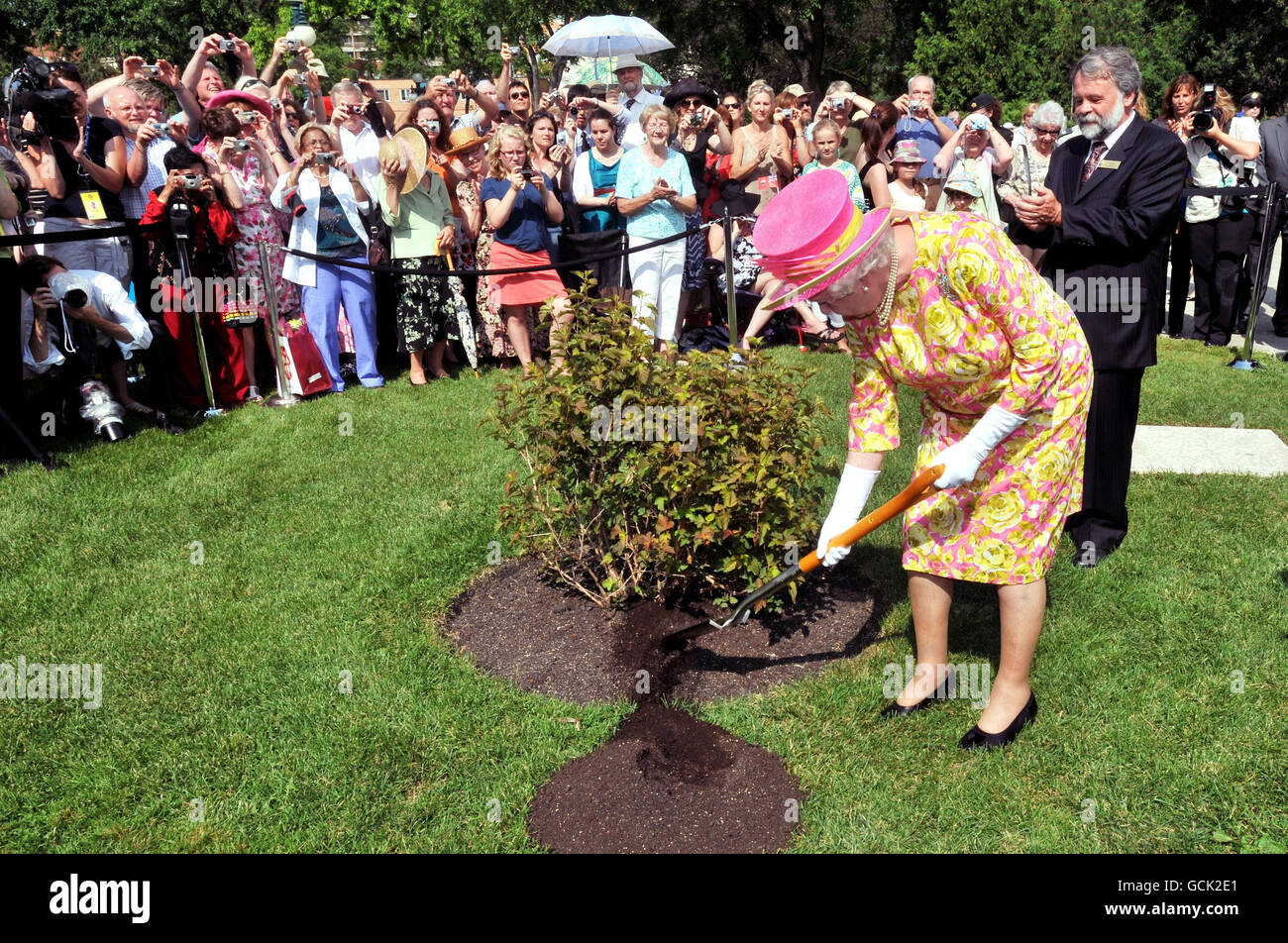 Britain's Queen Elizabeth II plants a tree in the garden of Government ...