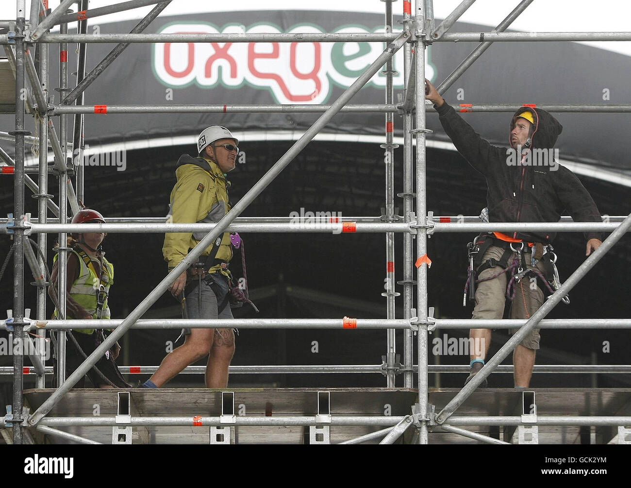 Construction workers build the sound desk for the main stage as concert ...