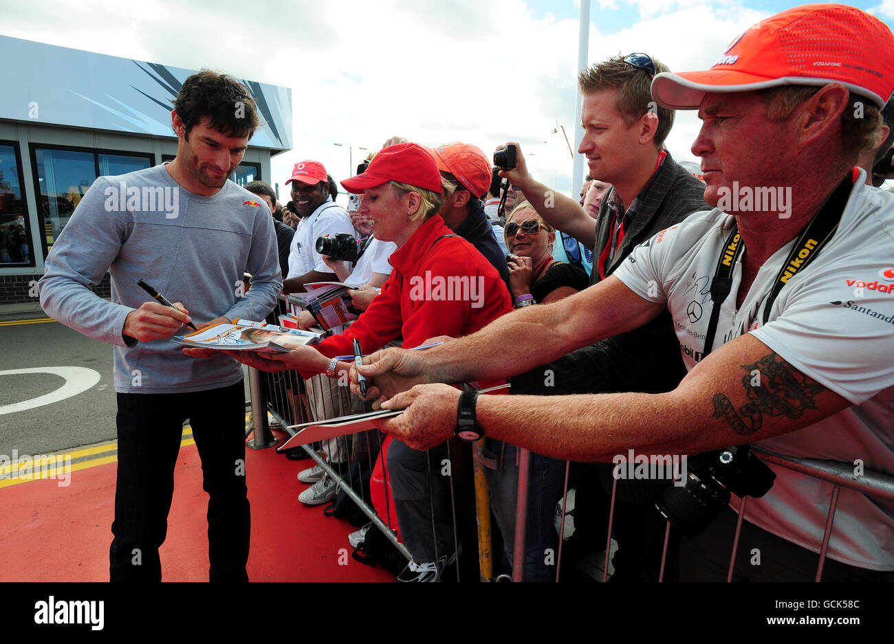 Red Bull Racing's Mark Webber signs autographs as he arrives before the ...