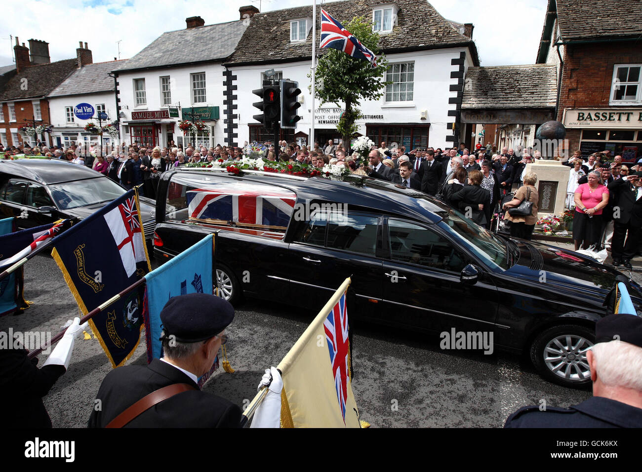 Flags are lowered as the bodies of Marine David Hart and Bombardier ...