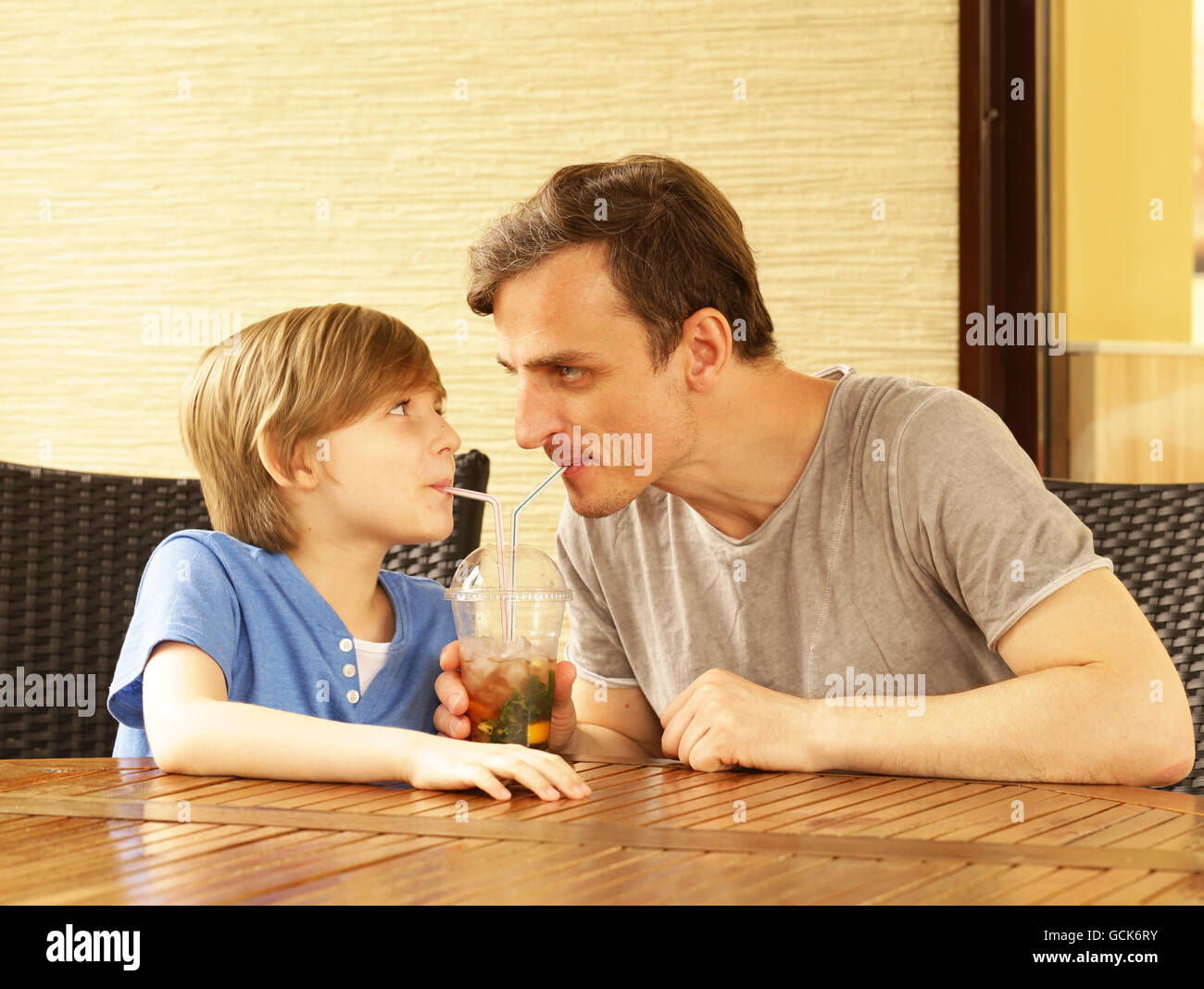 father and son in a cafe drinking ice tea Stock Photo - Alamy