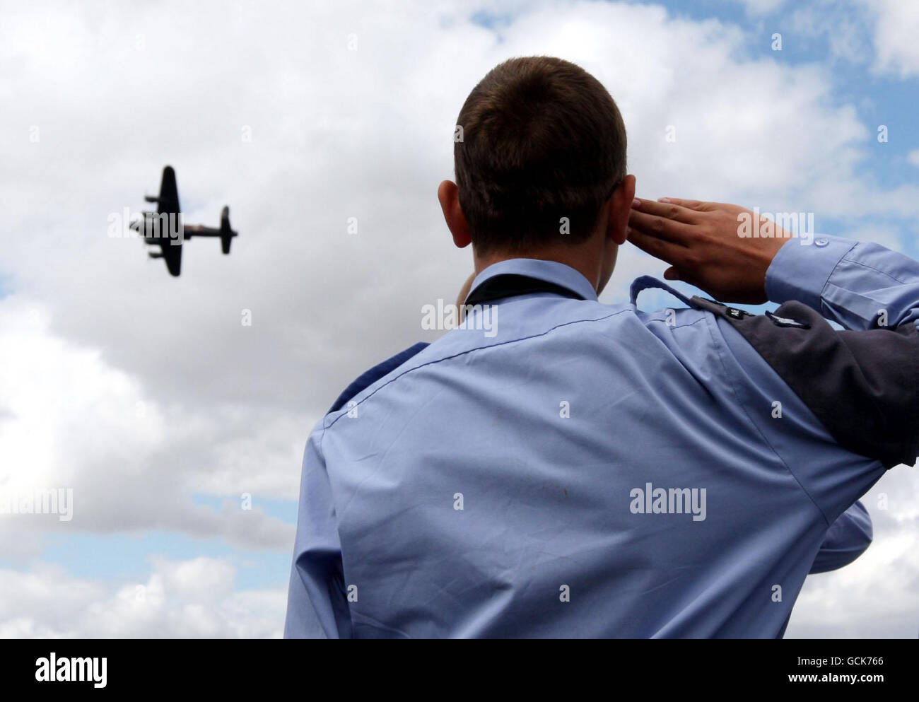 An Air Training Cadet salutes the Lancaster bomber as it flies past at ...