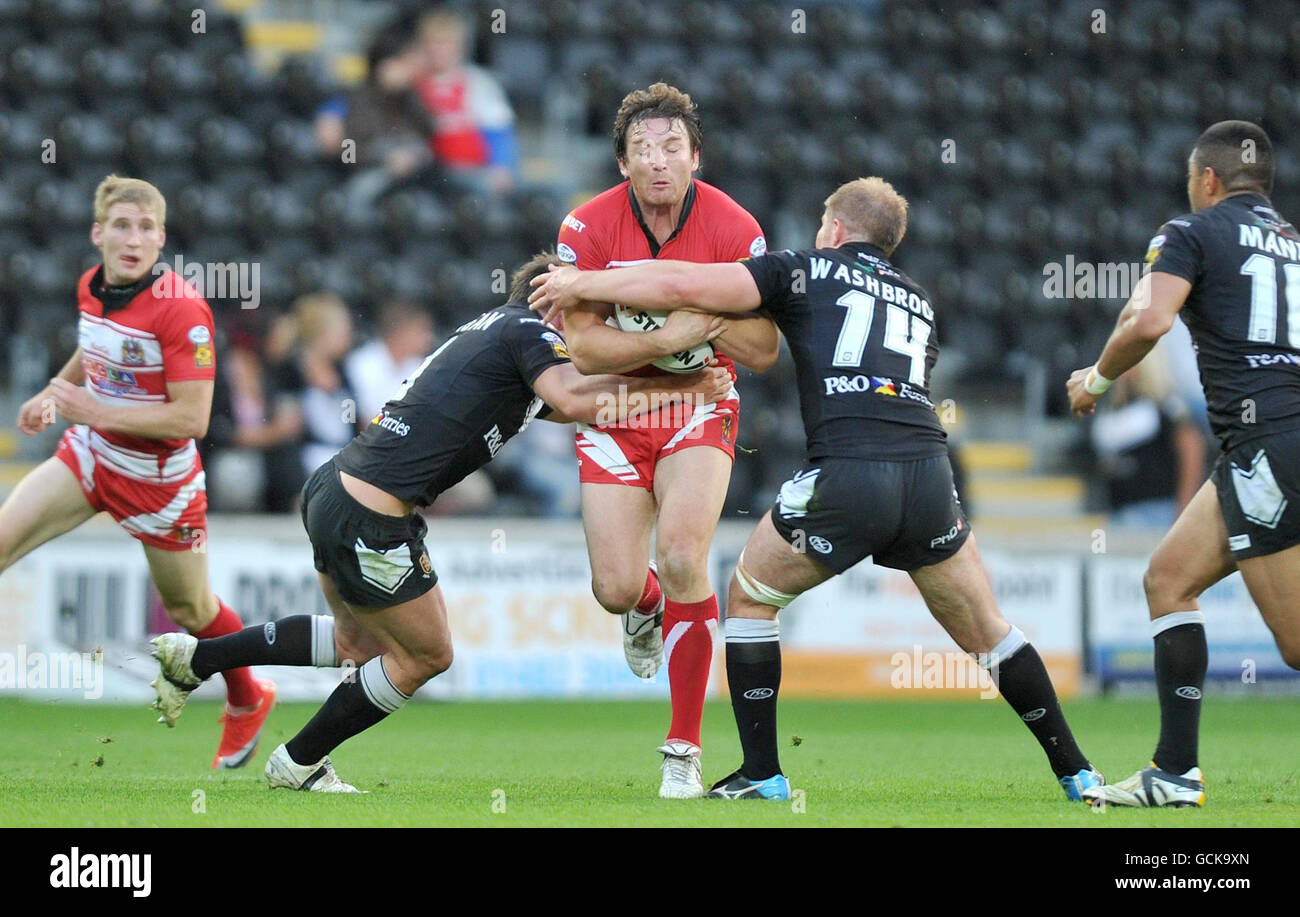 Wigans Martin Gleeson is tackled by Hull FC's Shaun Berrigan (left) and ...