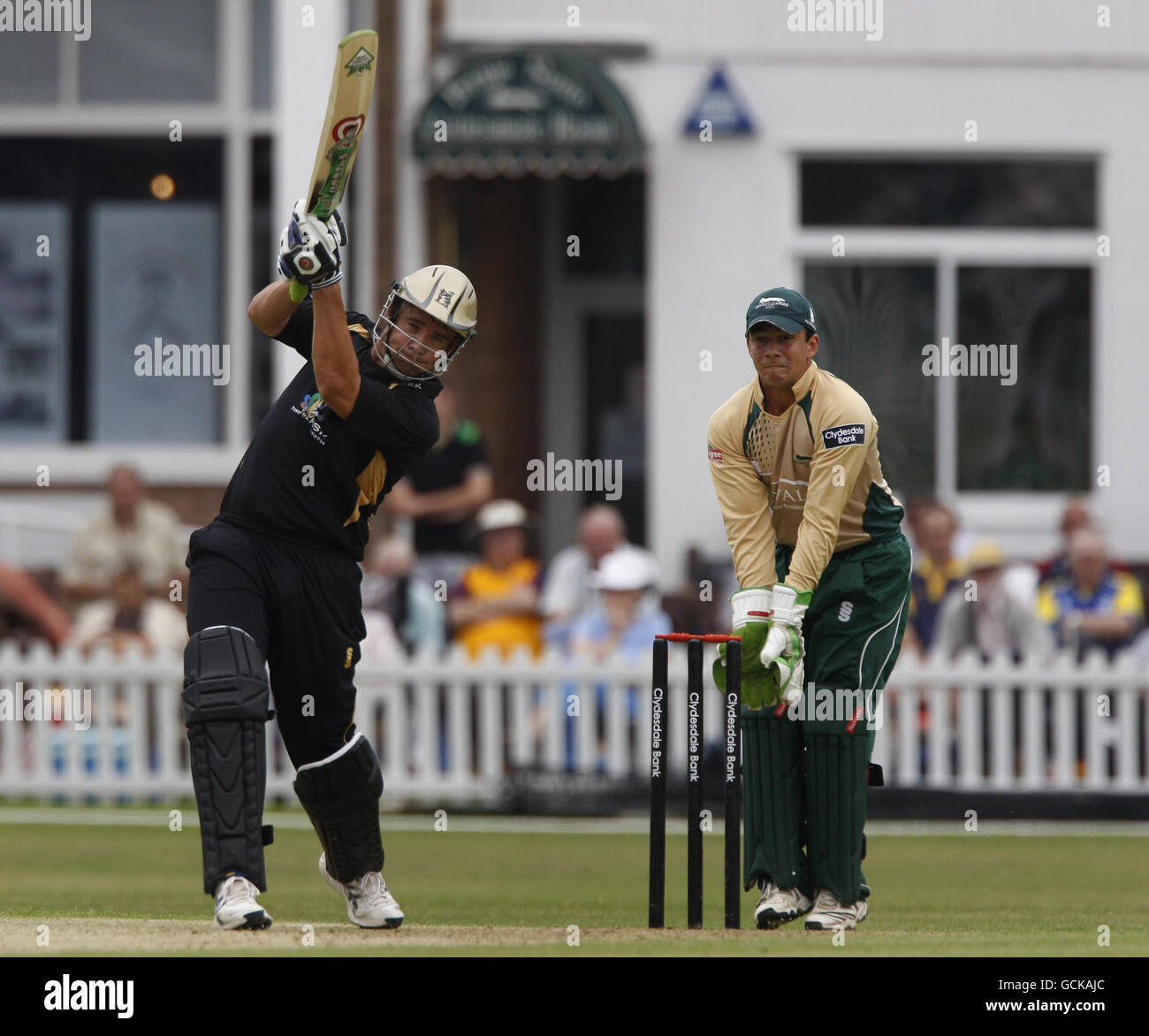 Warwickshire batsman Neil Carter smashes a 4 during his innings of 101 ...