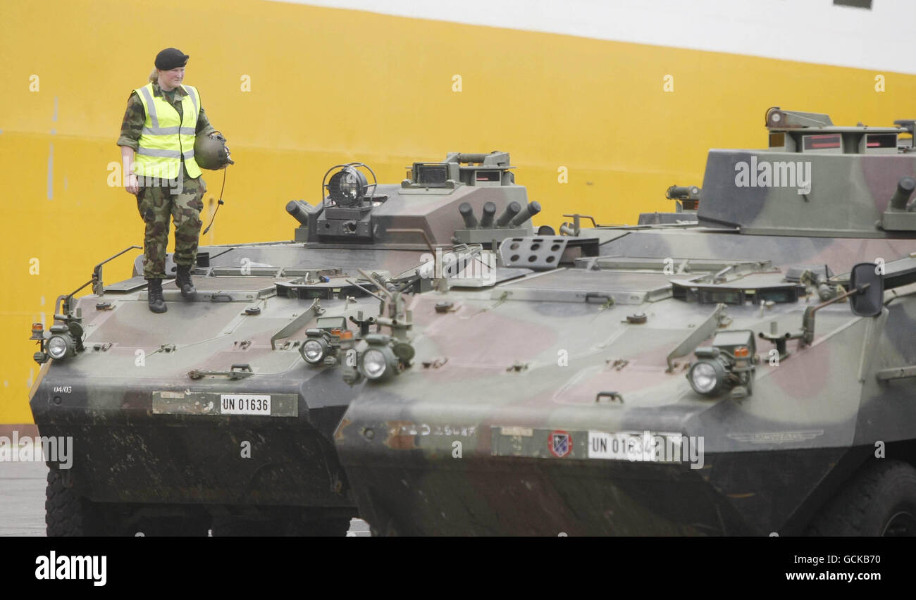 A member of the Defence forces climbs from a MOWAG Armoured Personnel ...
