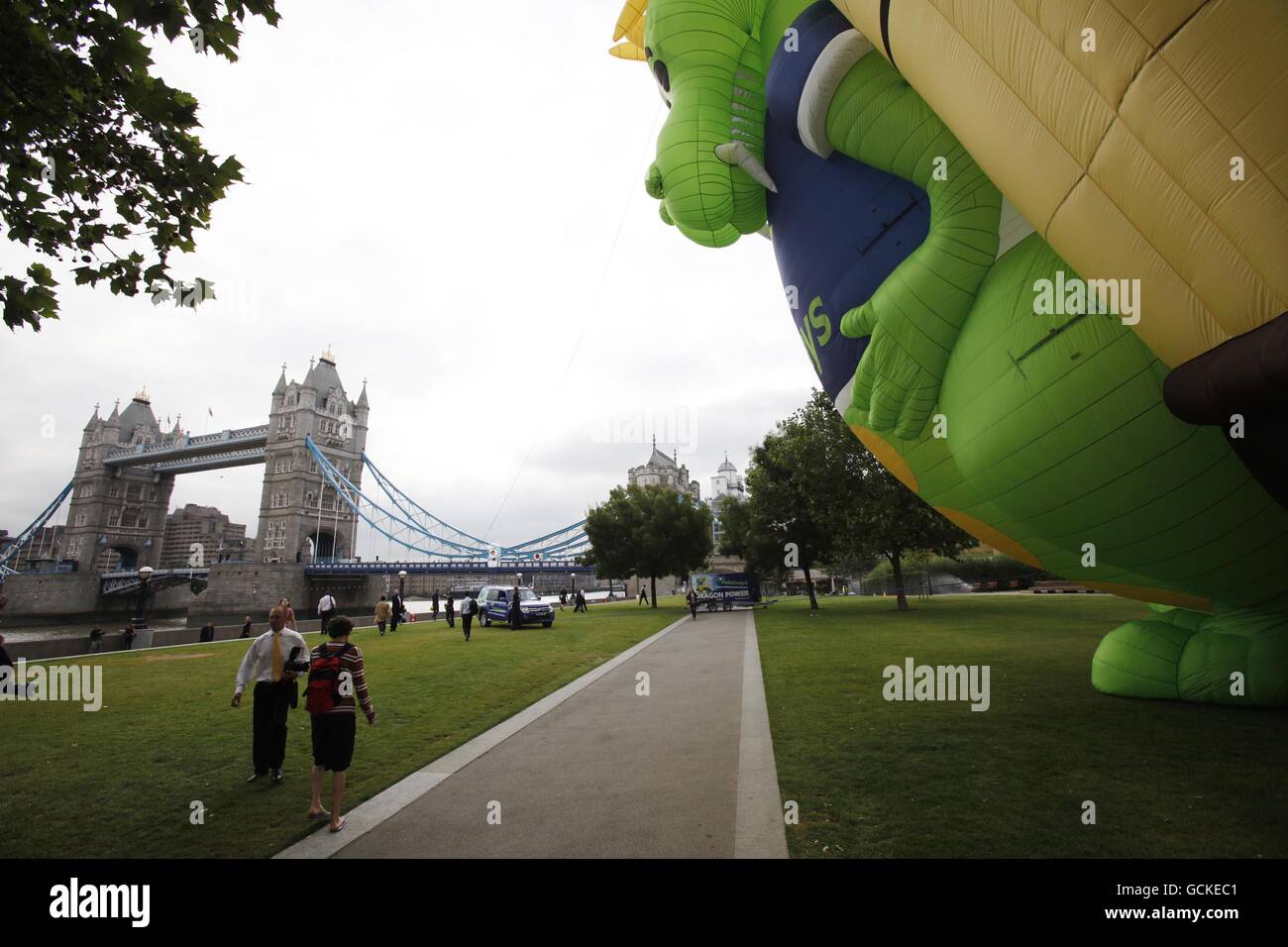 Commuters pass by a 61ft tall dragon shaped hot air balloon hi-res ...
