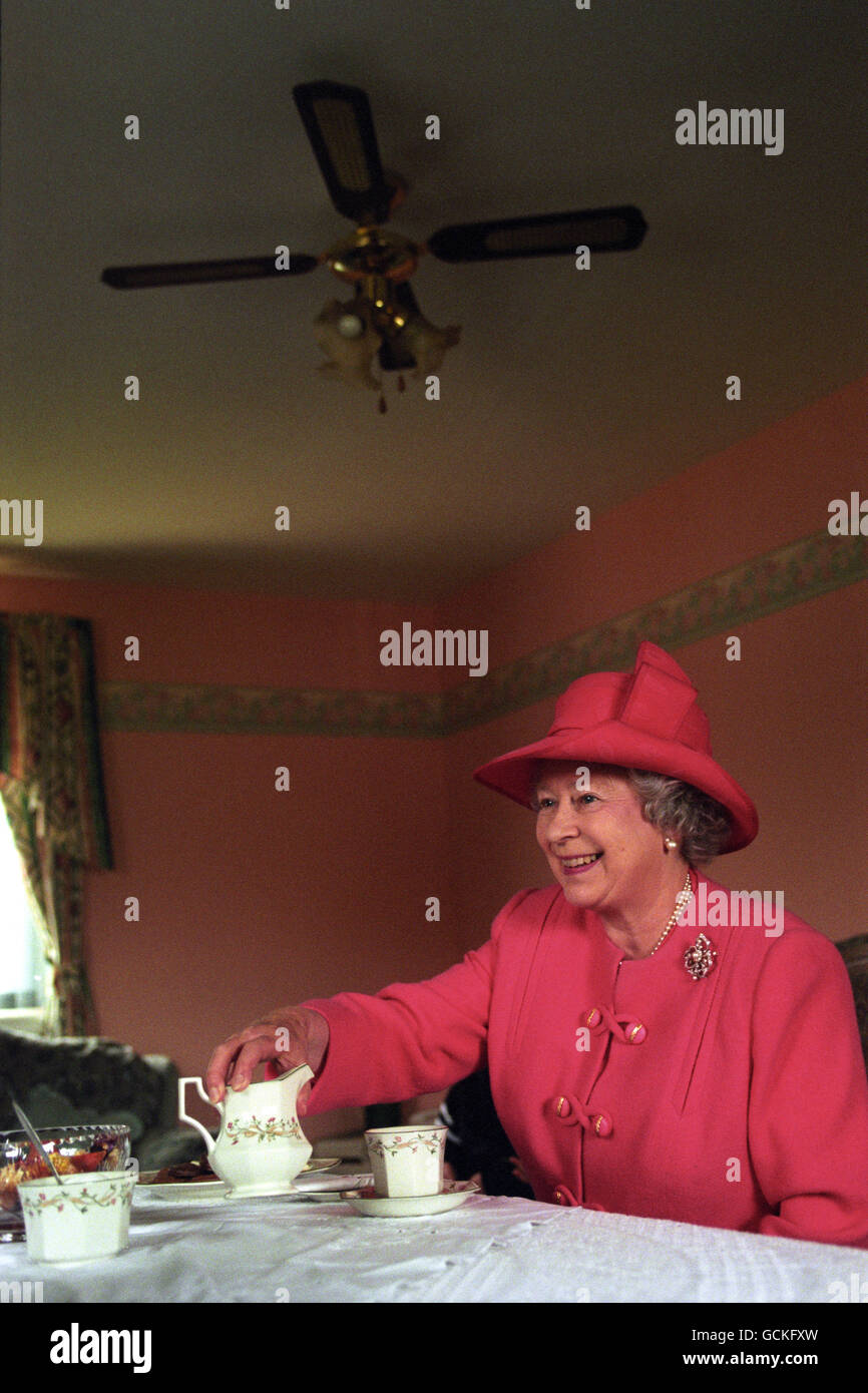 Queen Elizabeth II having tea in the home of Mrs Susan McCarron, in the ...
