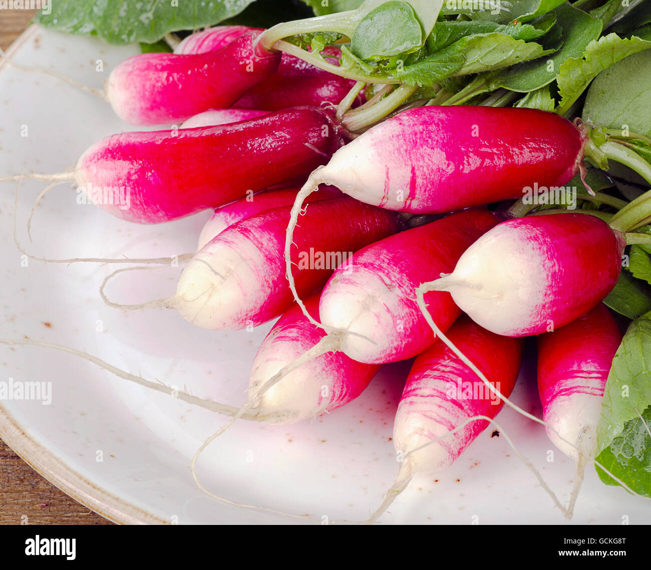 Bunch radishes on wooden plate hi-res stock photography and images - Alamy