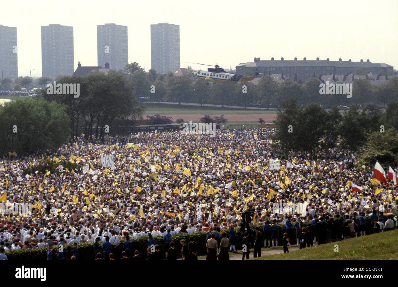 The huge crowd looks skyward as the helicopter carrying Pope John Paul ...
