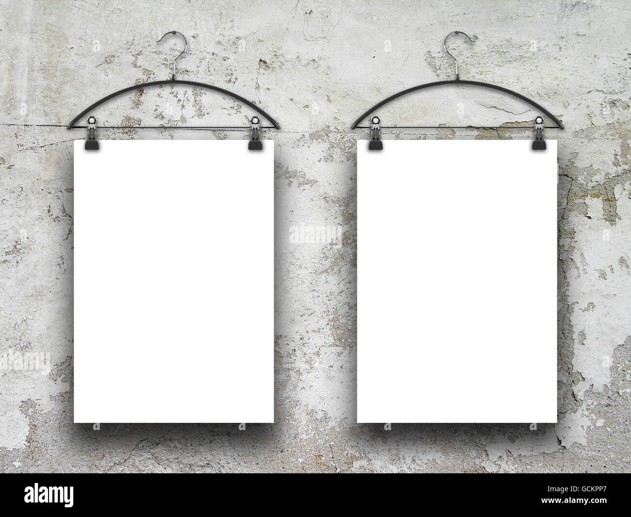 Close-up of two square blank frames hanged by clothes hanger against ...