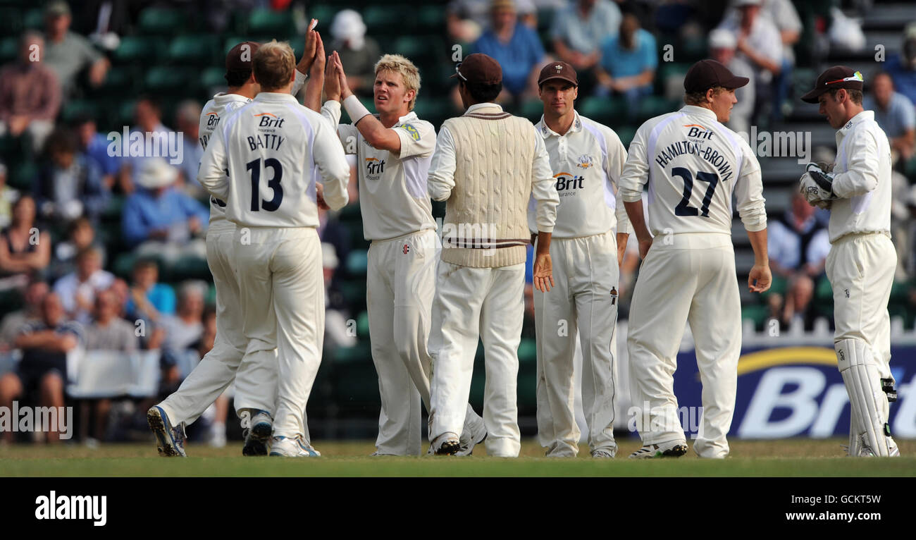Stuart Meaker celebrates with his Surrey team mates after taking the ...
