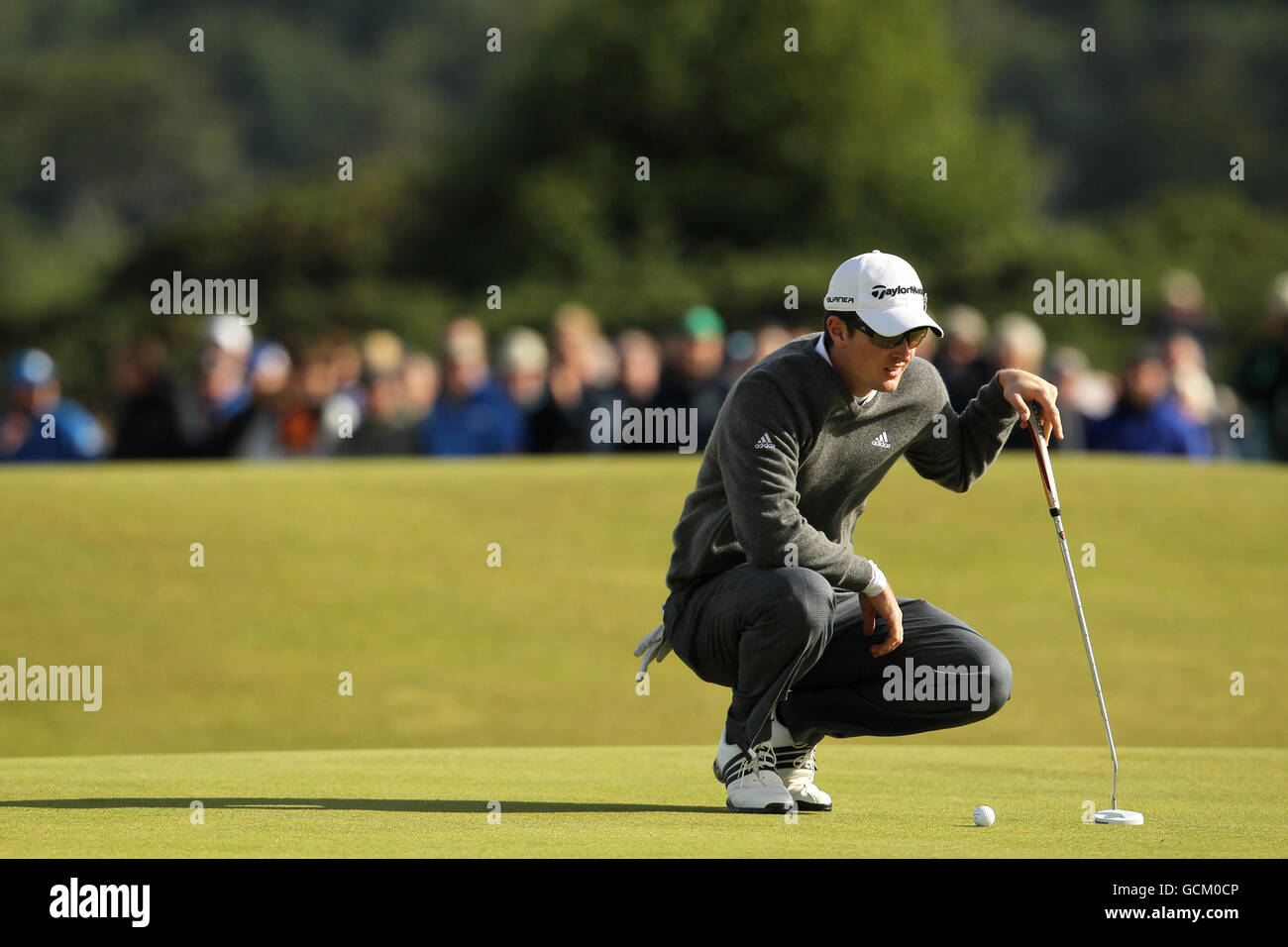 England's Justin Rose lines up his putt during round two of The Open ...