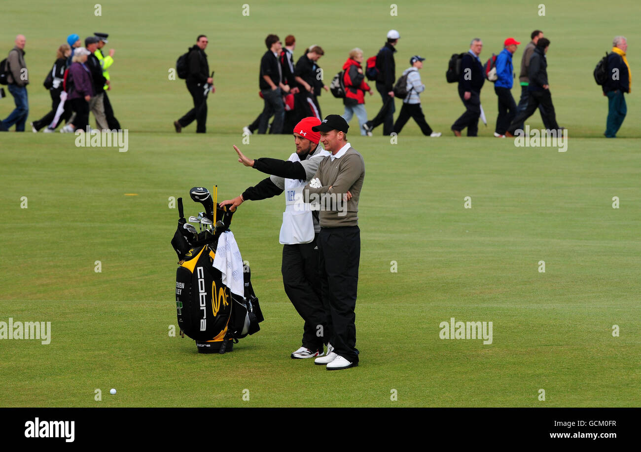 England's Steven Tiley (front right) discusses tactics with his caddie ...